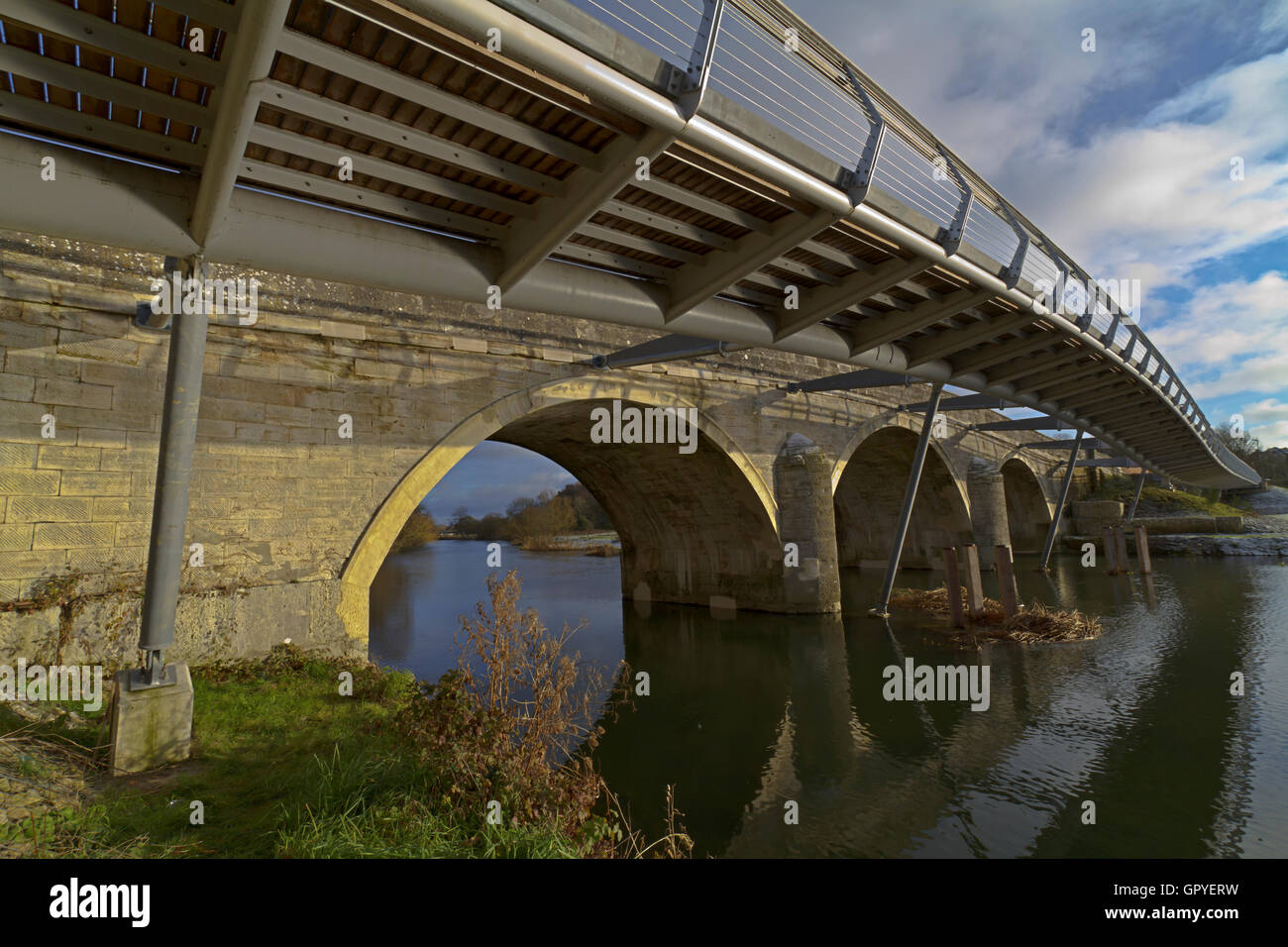 HDR image of an old road bridge with new foot bridge spanning the river ...