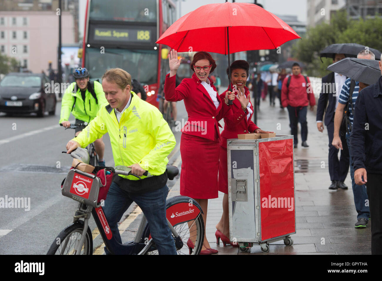 EDITORIAL USE ONLY Jayne Milne (left) and Tasha Chetty serve commuters ...