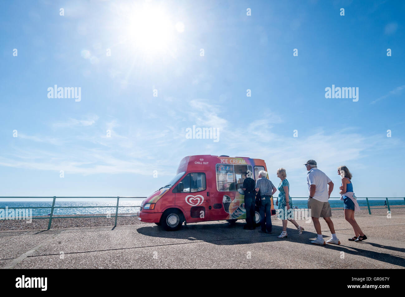 Customers queue for an ice-cream on the seafront at Brighton Stock ...