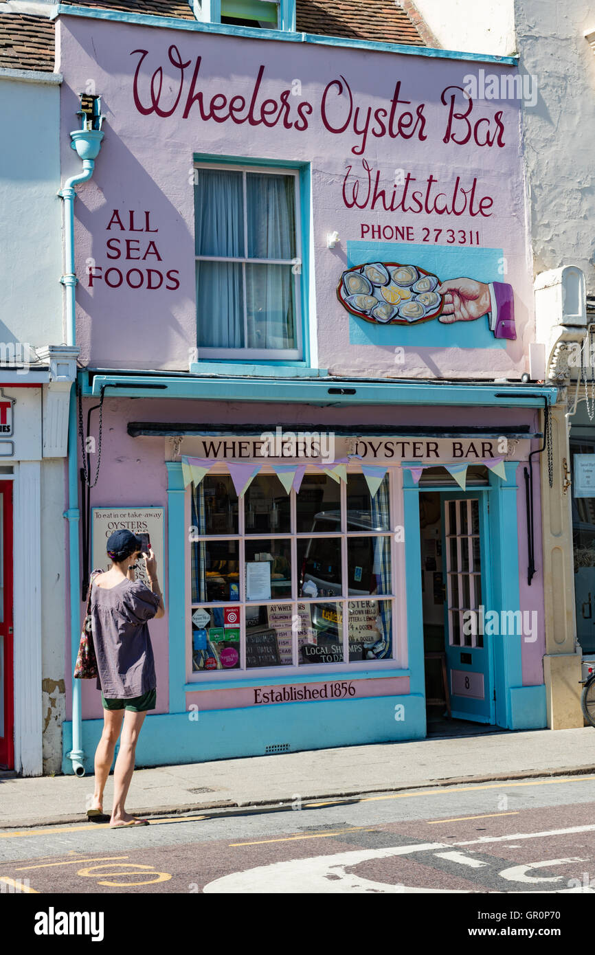 A woman uses her phone to photograph the famous Wheelers Oyster Bar ...