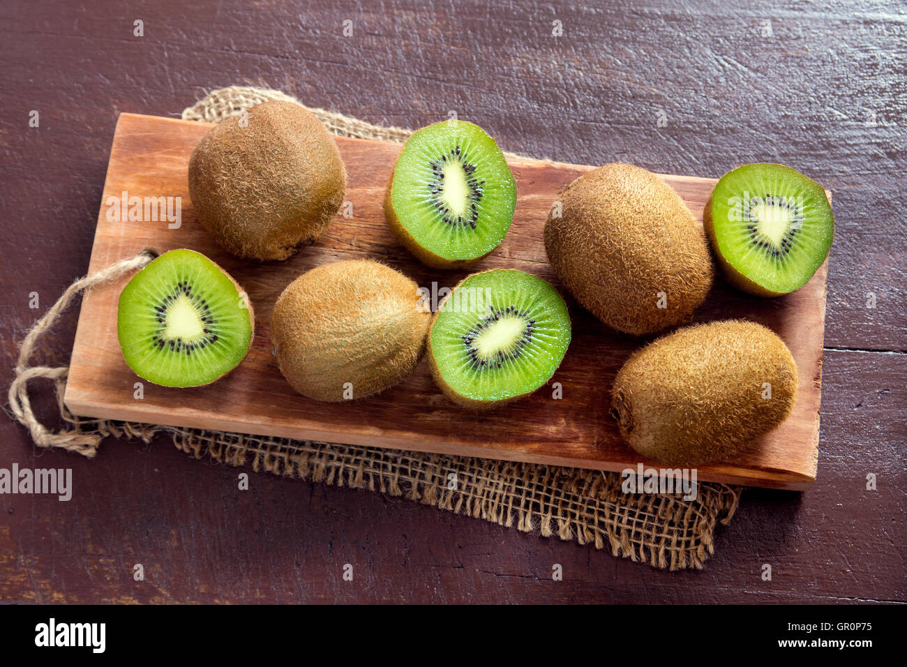 Kiwi fruits on wooden background Stock Photo - Alamy