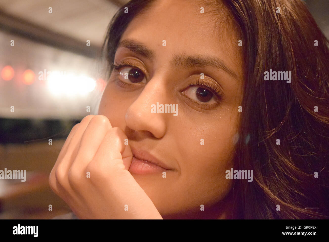 Face of Indian girl with chin on hand Stock Photo - Alamy