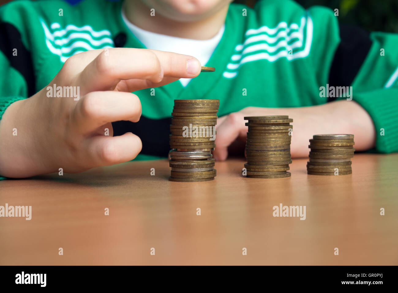 Child counting coins hi-res stock photography and images - Alamy