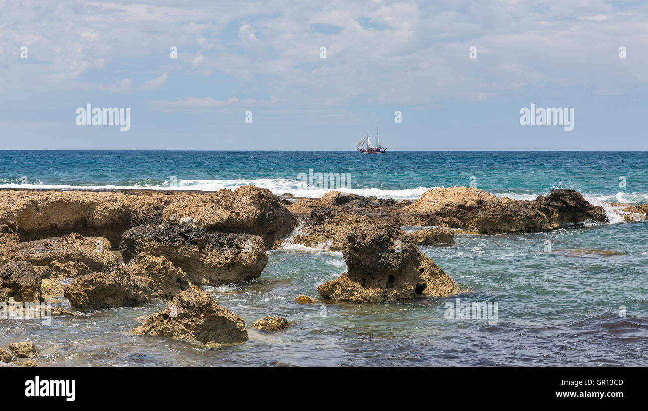 Seascape with sail ship and stones in Paphos, Cyprus Stock Photo - Alamy