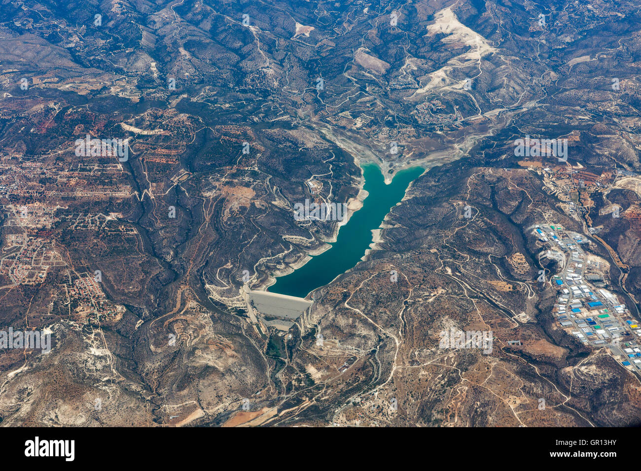 Aerial view from airplane of Kouris Dam and 3rd Limassol Industrial ...