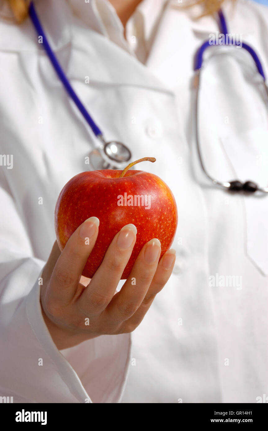 doctor handing a red apple Stock Photo - Alamy