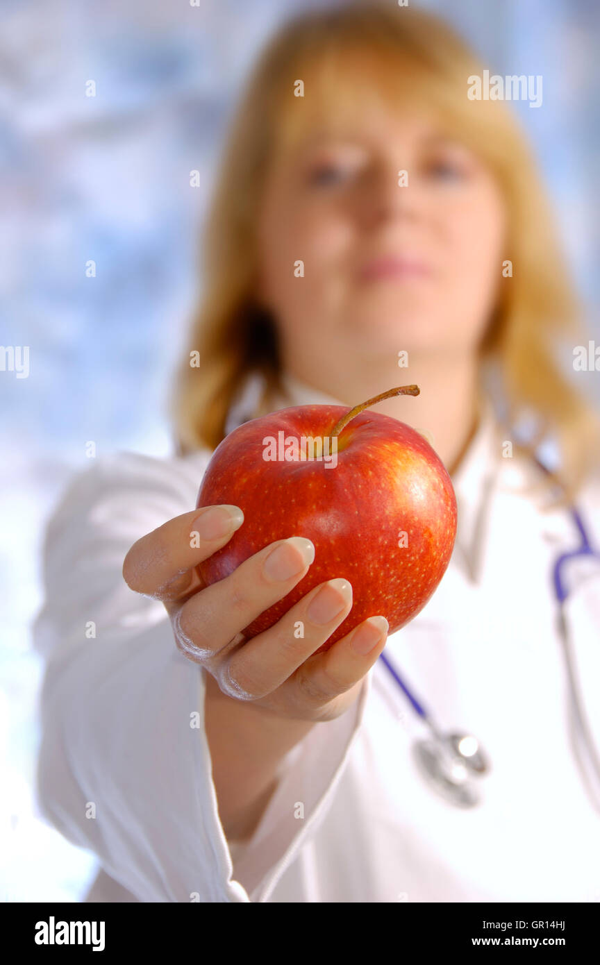 doctor handing a red apple Stock Photo - Alamy