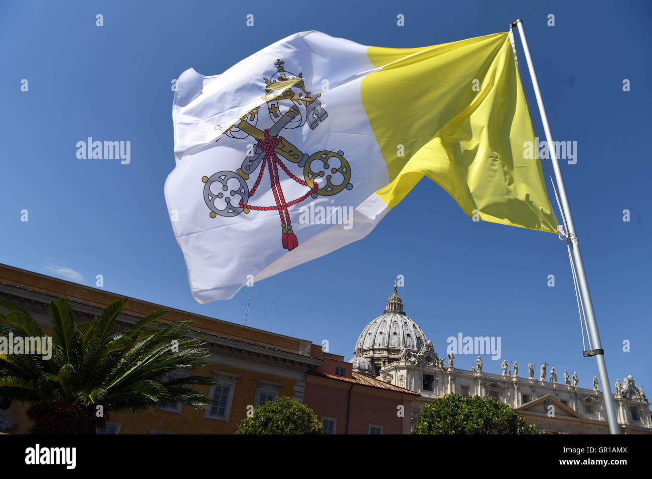 A flag with the coat of arms of Vatican City waves in Vatican City, 02 ...