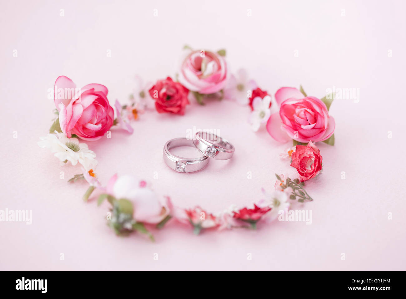 Wedding rings with flowers Stock Photo - Alamy
