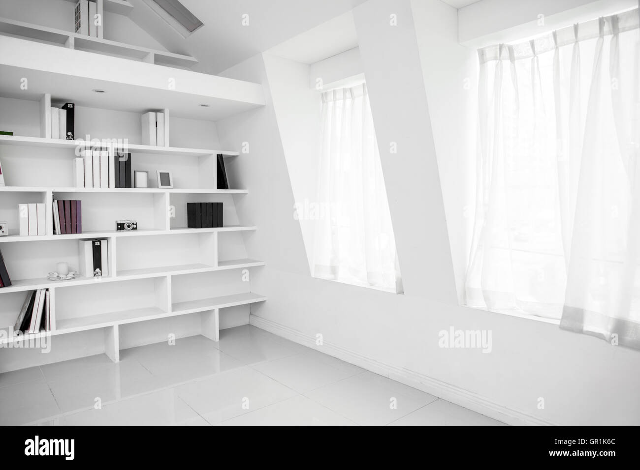 Interior with bookcases and windows Stock Photo - Alamy