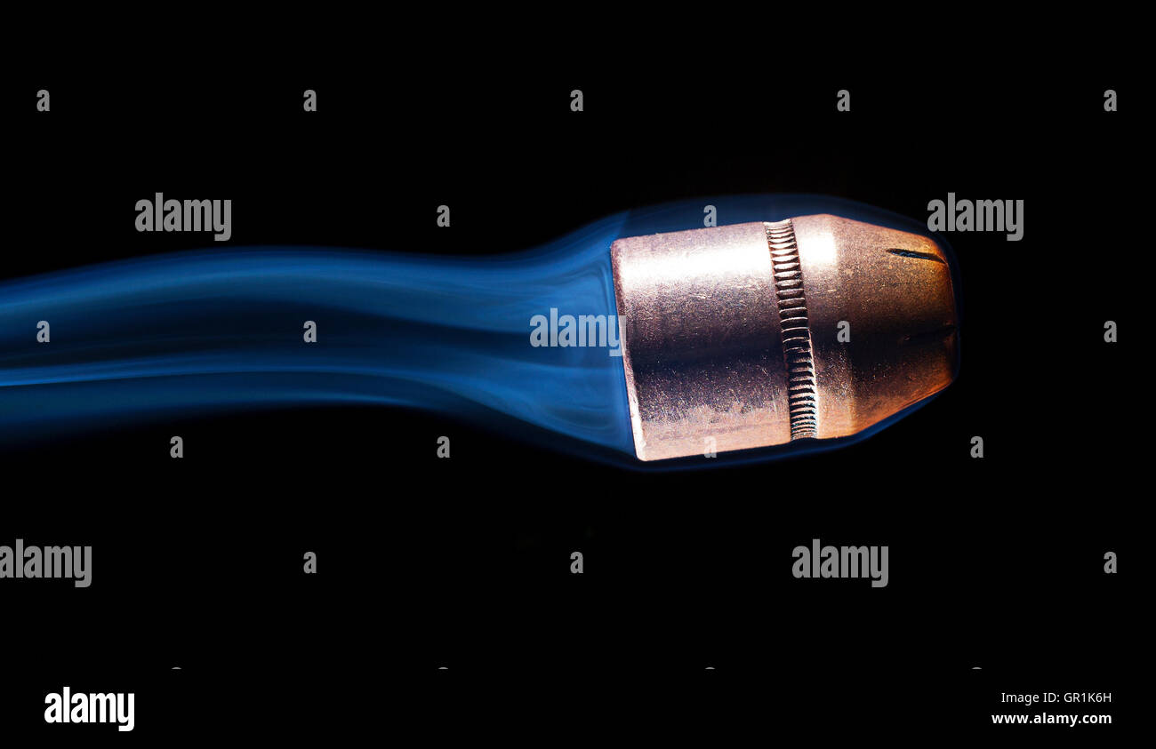 Copper handgun bullet that has a smoke trail behind Stock Photo - Alamy