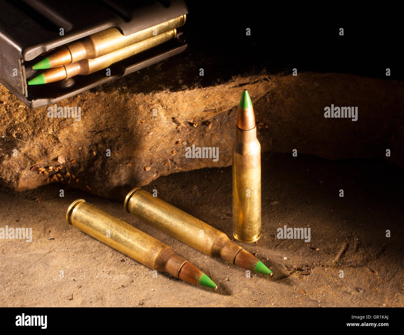 Three rifle cartridges with green tips and a loaded magazine Stock ...