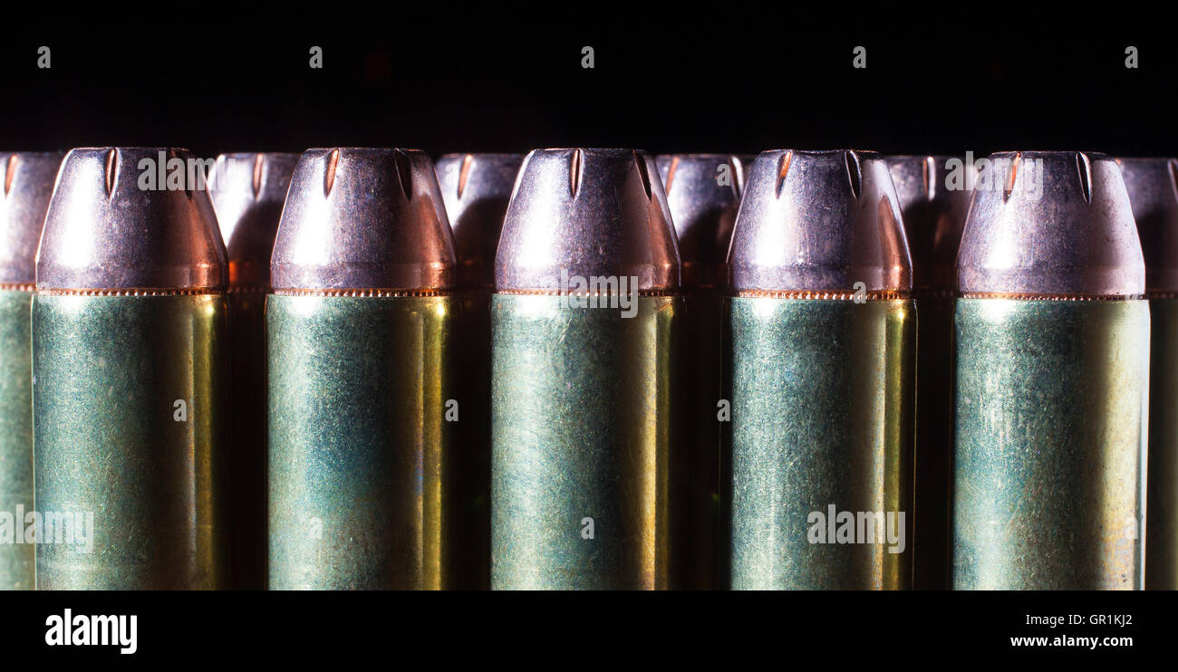 Line of forty four magnum hollowpoint cartridges with a black ...