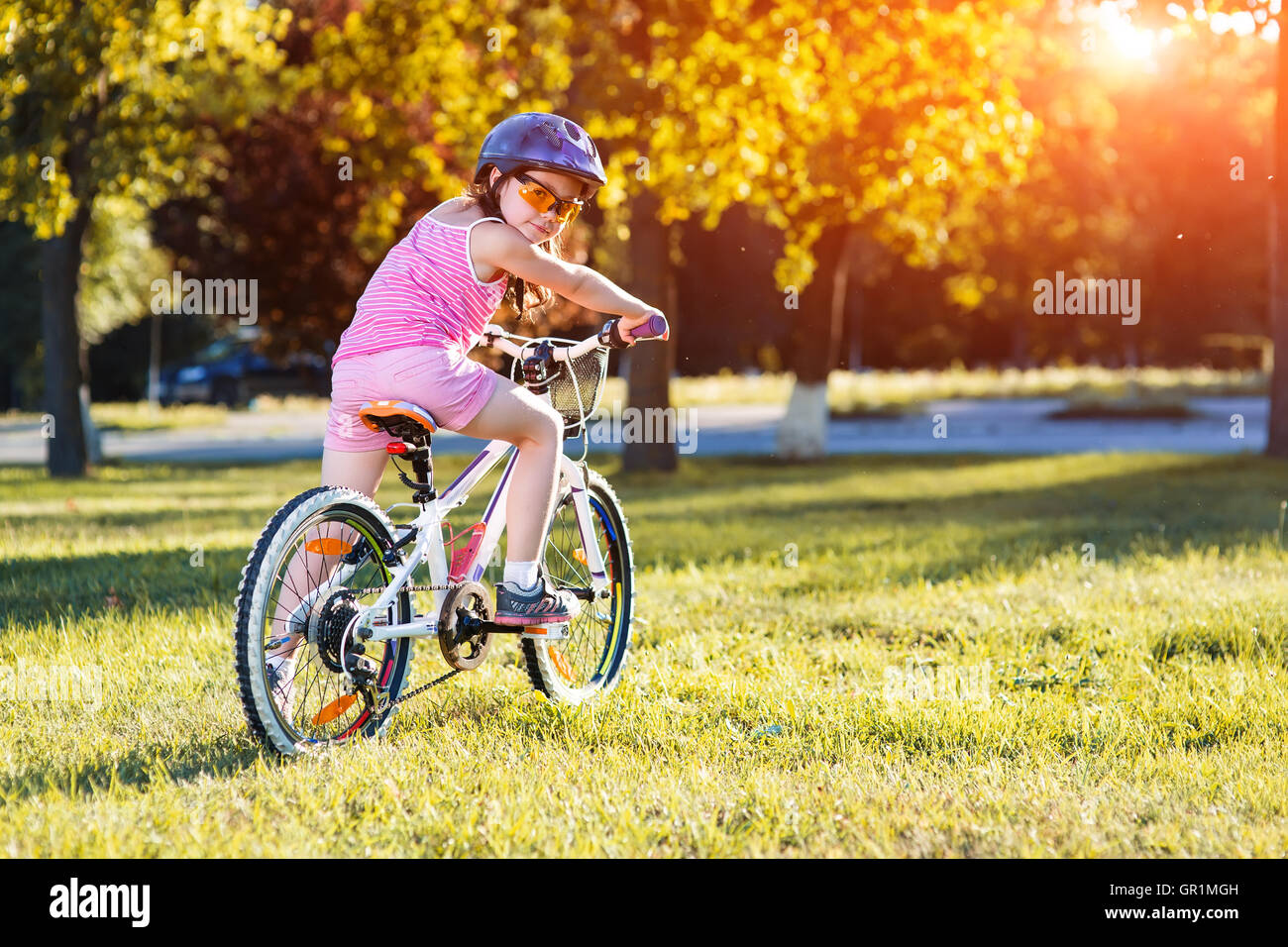 Child riding a bicycle. The kid in helmet on bike Stock Photo - Alamy
