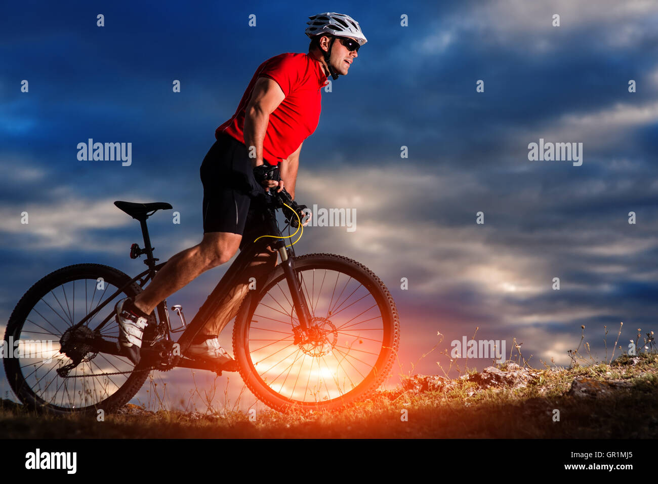 mountain bicycle rider on the hill with sunrise background Stock Photo ...