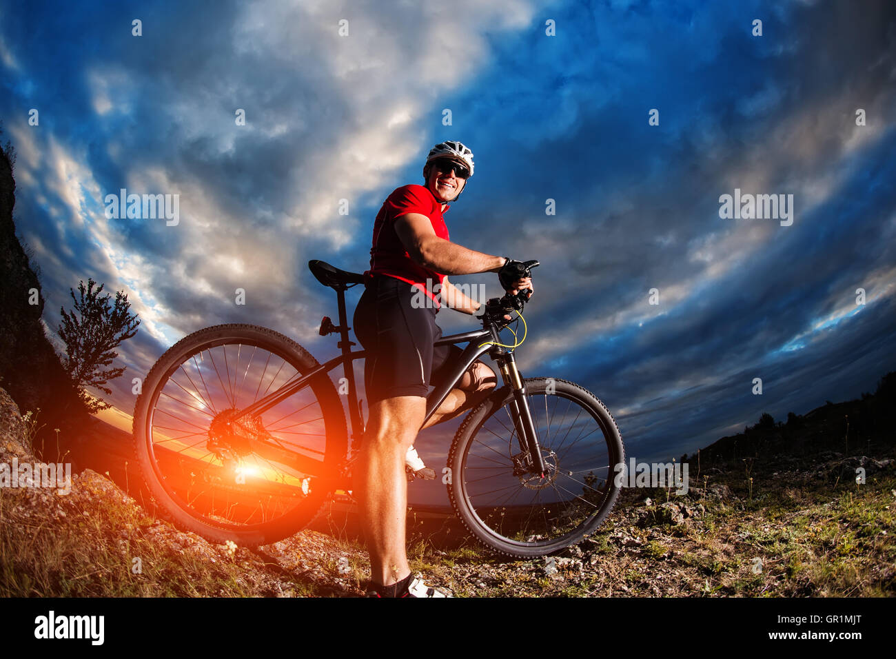 mountain bicycle rider on the hill with sunrise background Stock Photo ...