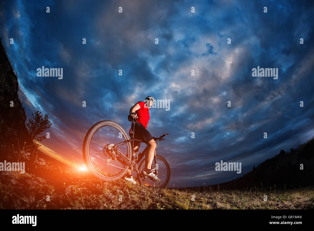 mountain bicycle rider on the hill with sunrise background Stock Photo ...