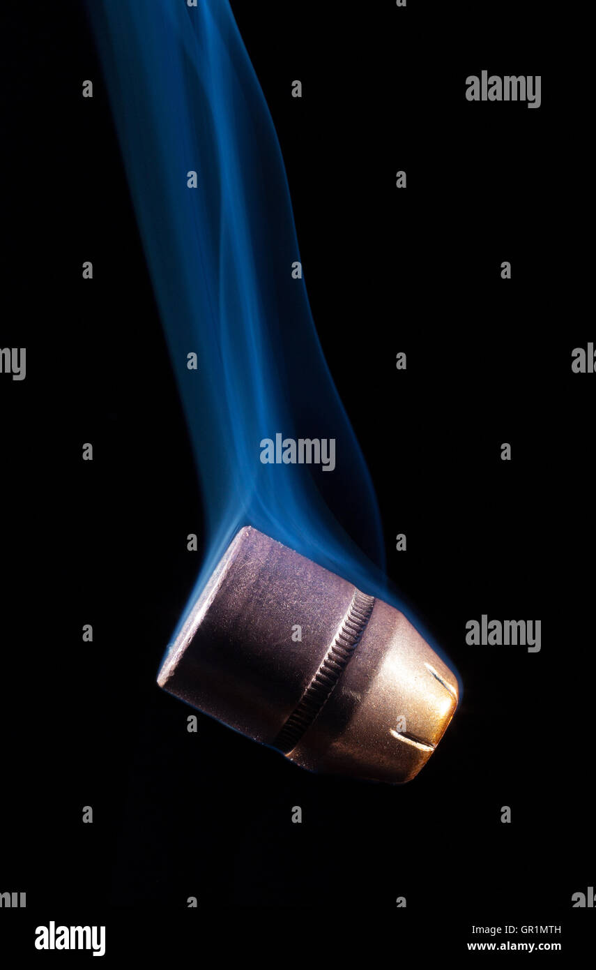 Handgun bullet that looks like it is dropping with smoke behind Stock ...