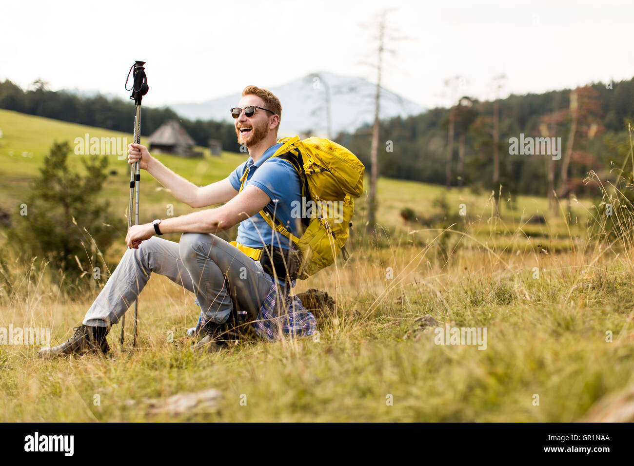 Young backpacking man rest at the hill Stock Photo - Alamy