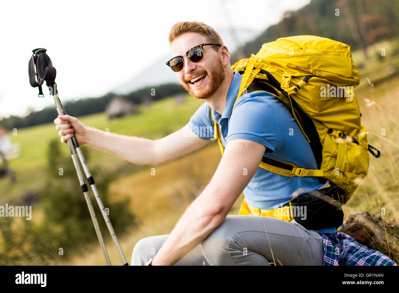 Young backpacking man rest at the hill Stock Photo - Alamy