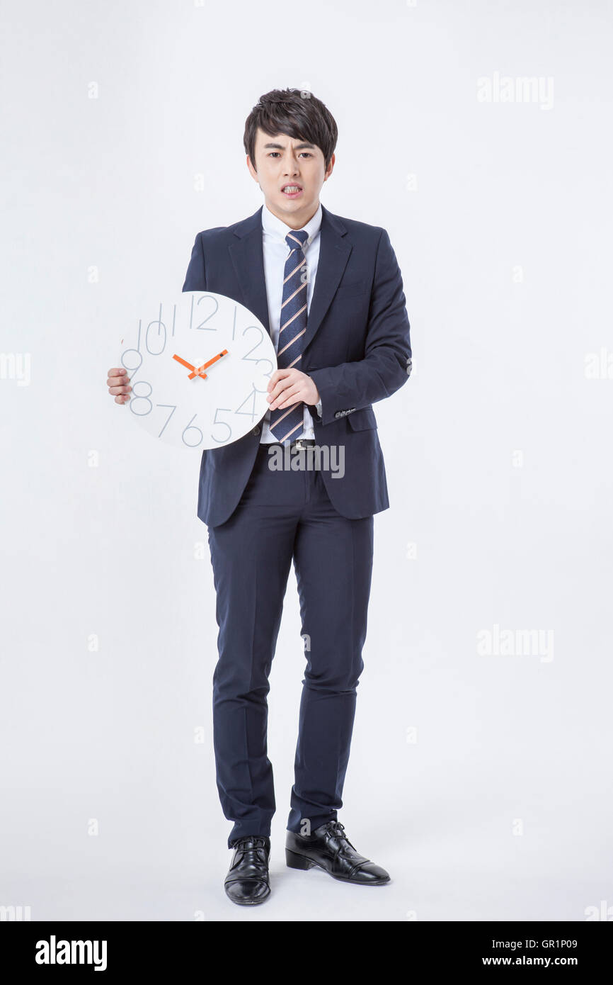Businessman showing clock Stock Photo - Alamy