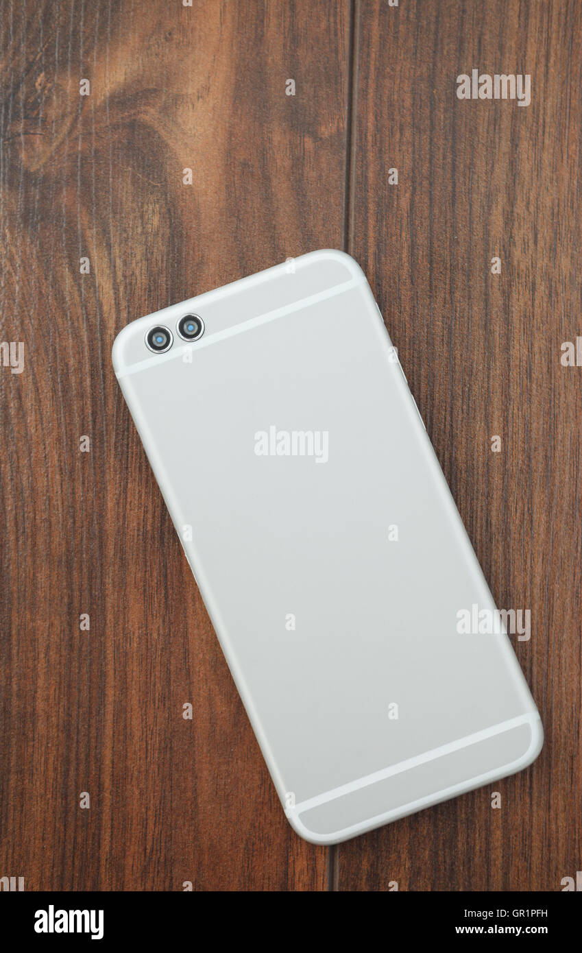 Future model of modern dual lens camera smart mobile phone on wooden ...