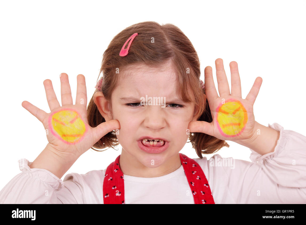 angry little girl with angry smiley on hands Stock Photo - Alamy