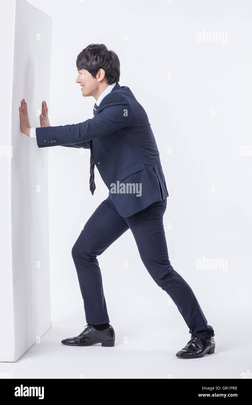 Pushing a wall hi-res stock photography and images - Alamy