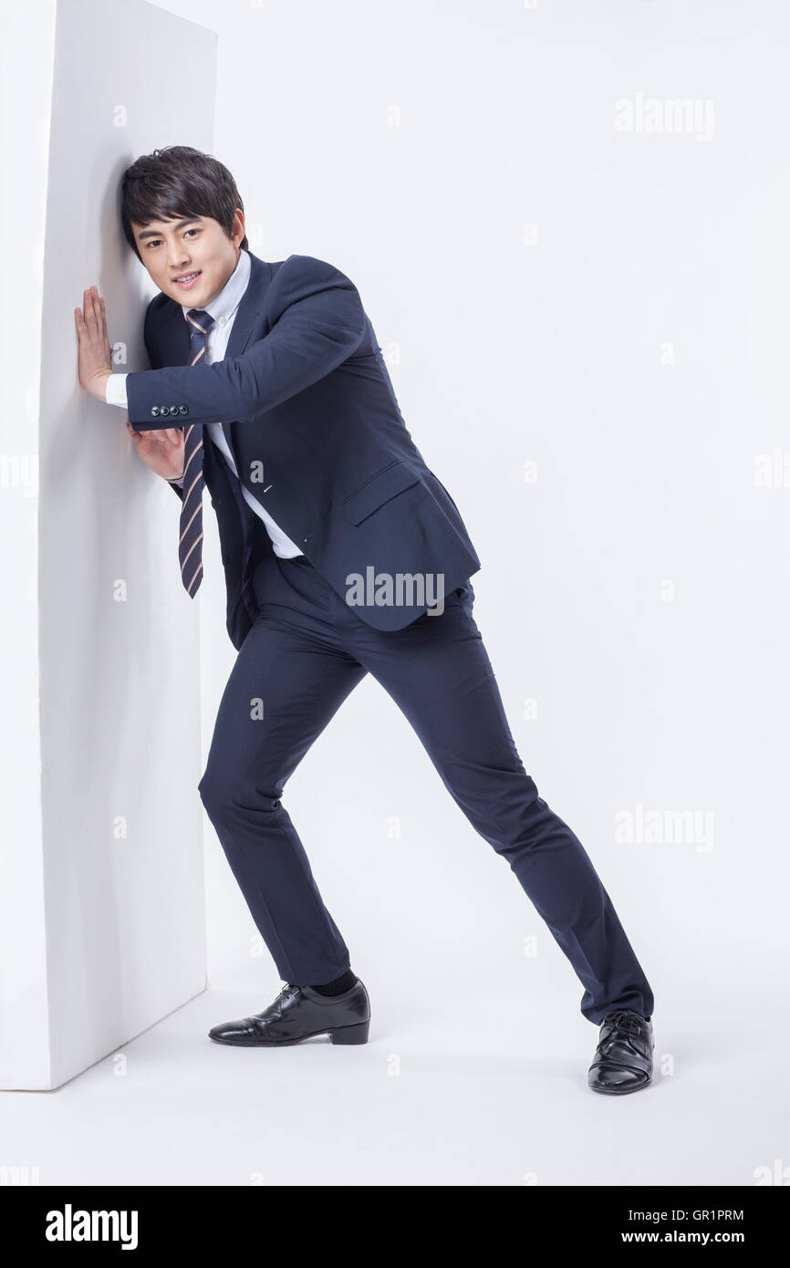 Pushing a wall hi-res stock photography and images - Alamy