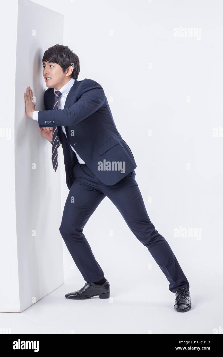 Pushing a wall hi-res stock photography and images - Alamy