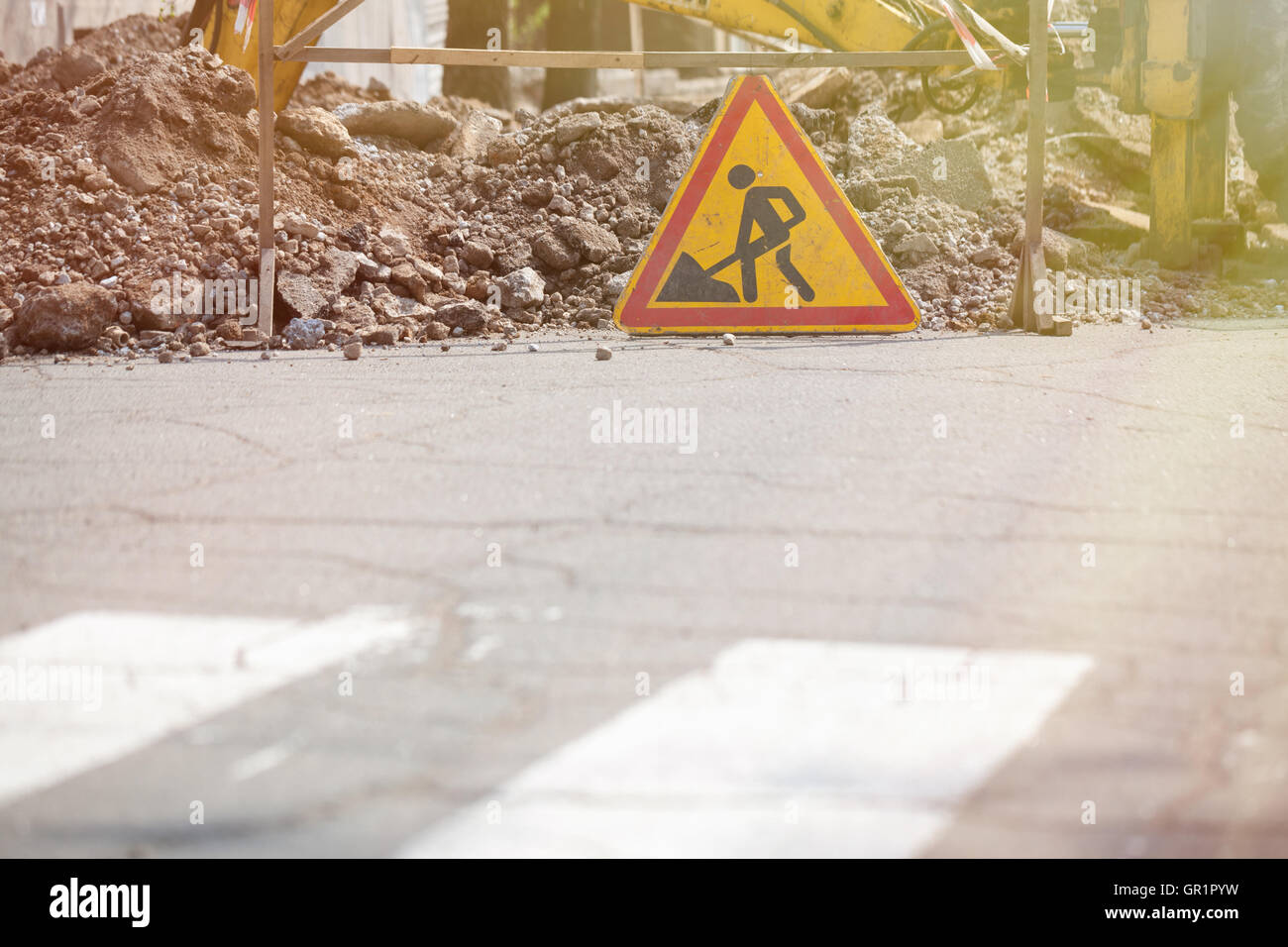 This road is under construction and closed. Yellow safety sign warns ...