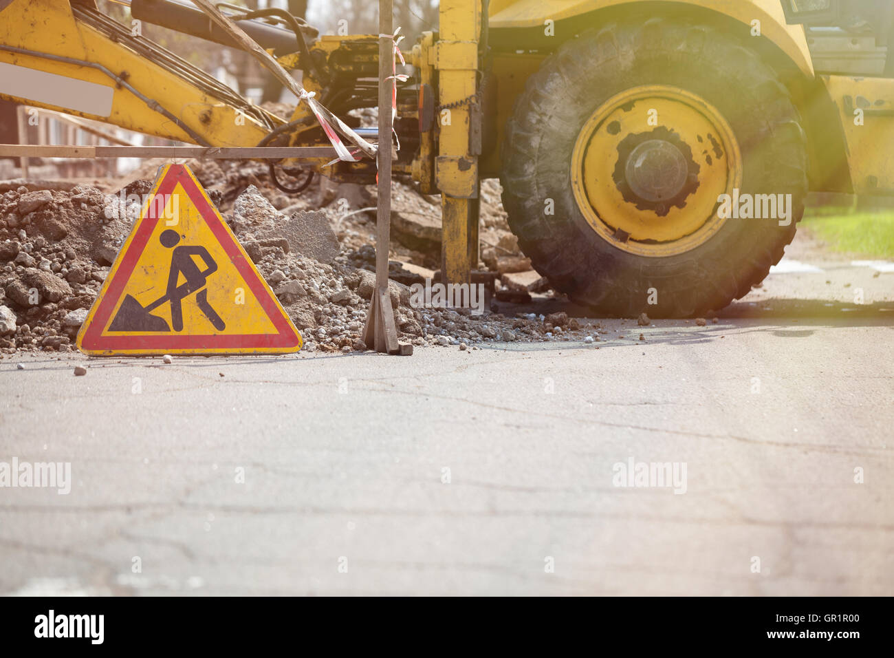 This road is under construction and closed. Yellow safety sign warns ...