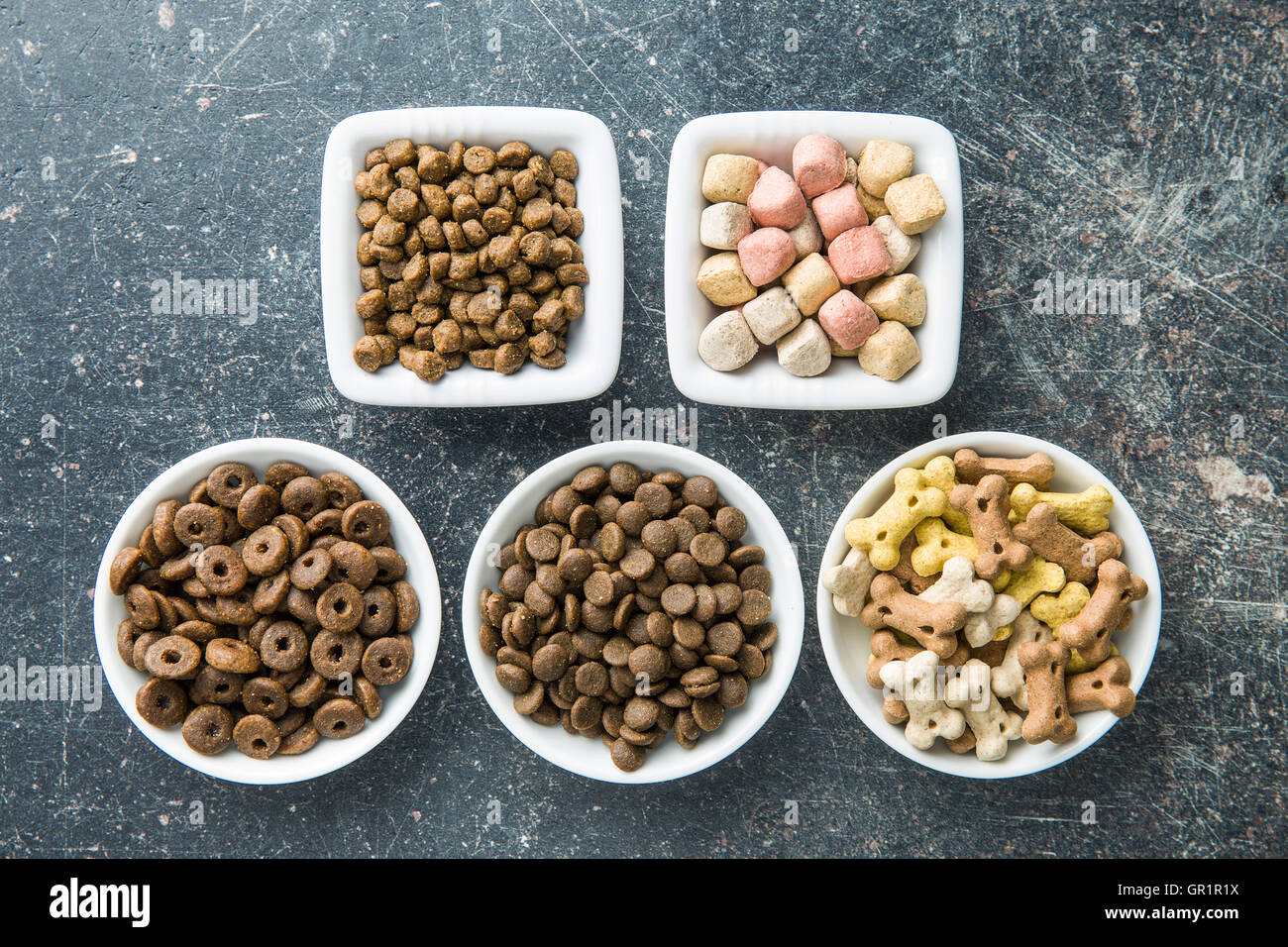 Different dog foods in bowls. Top view Stock Photo - Alamy