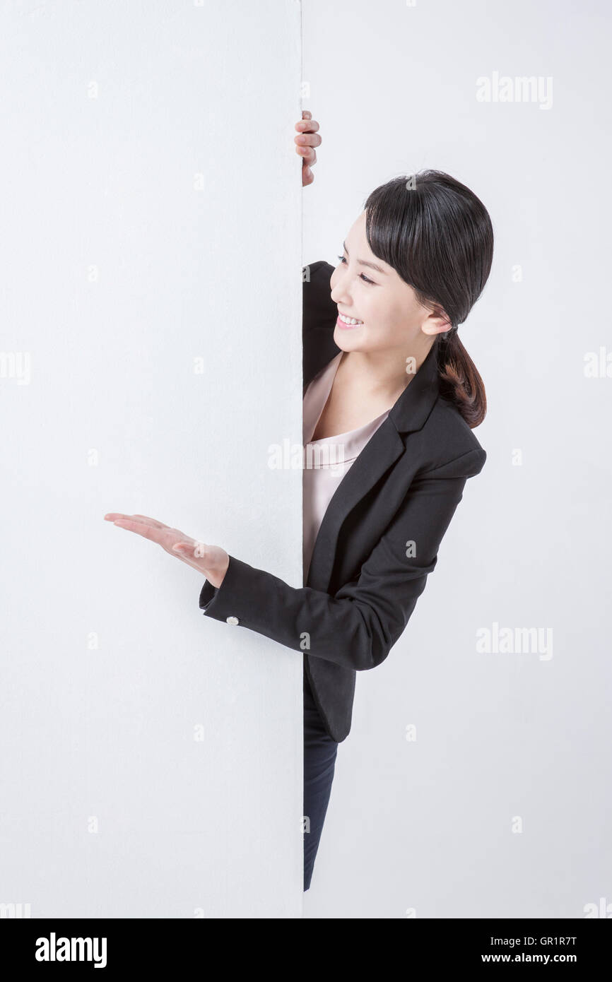 Smiling businesswoman showing banner Stock Photo - Alamy