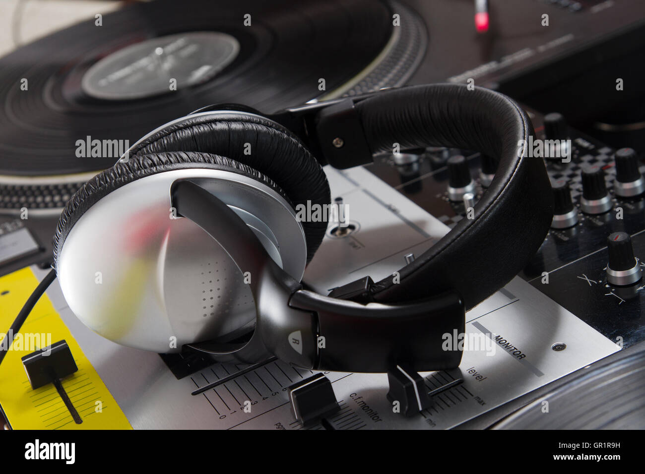 Professional dj headphones lying on sound mixing controller. Turntables ...