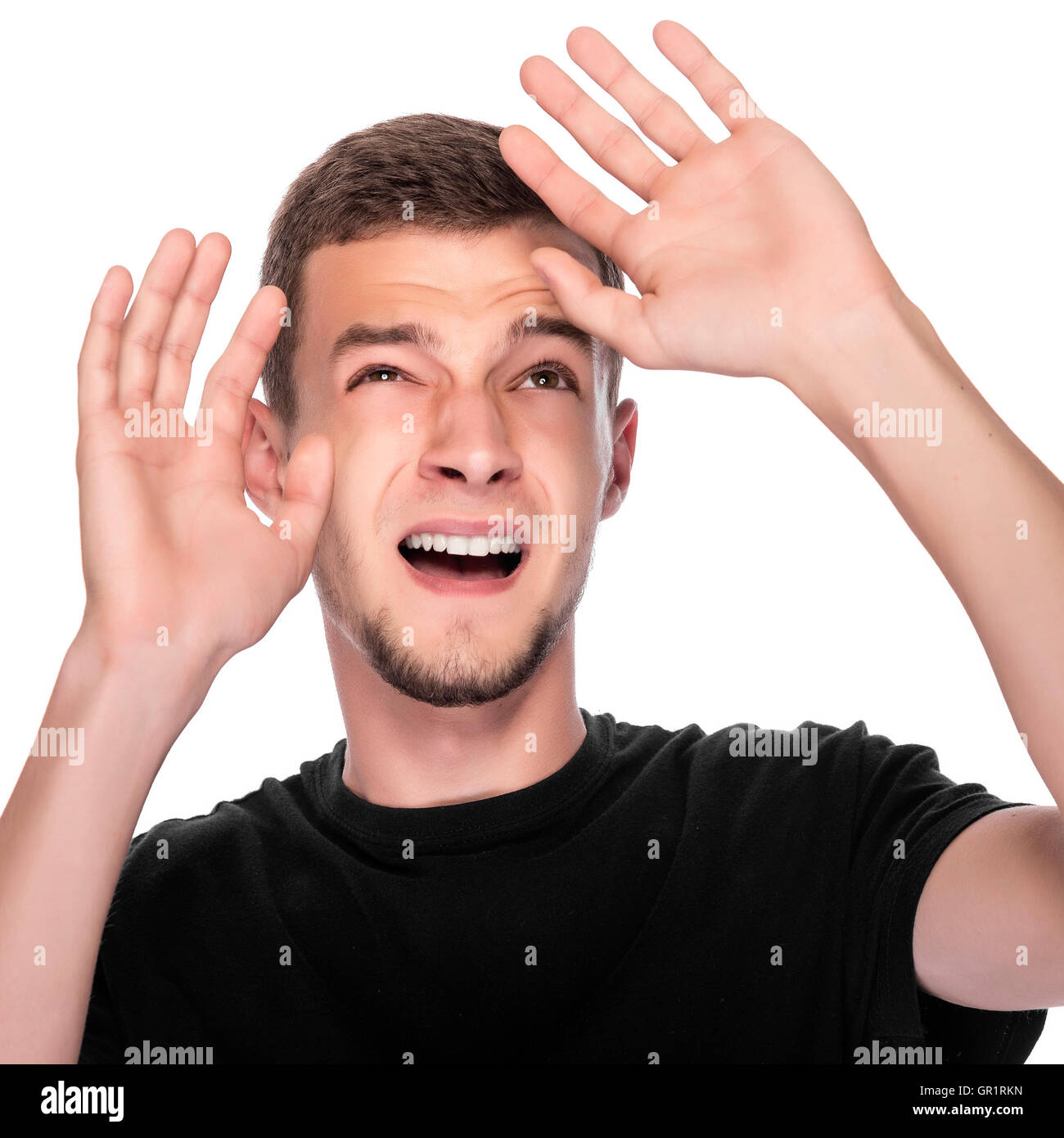 Young man in fear of concealed hands. On white Stock Photo - Alamy
