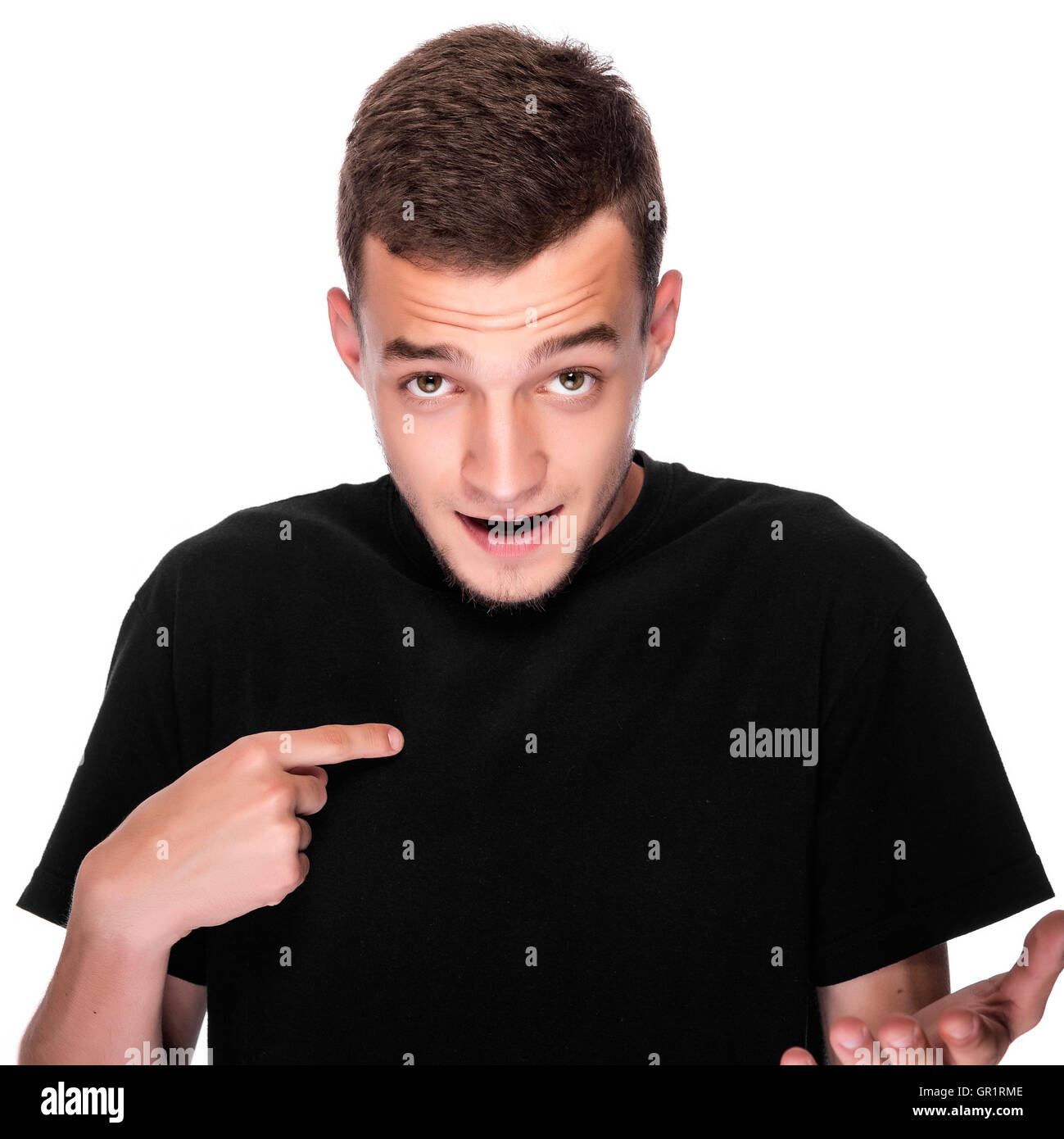 Young man in a misunderstanding on dark background Stock Photo - Alamy