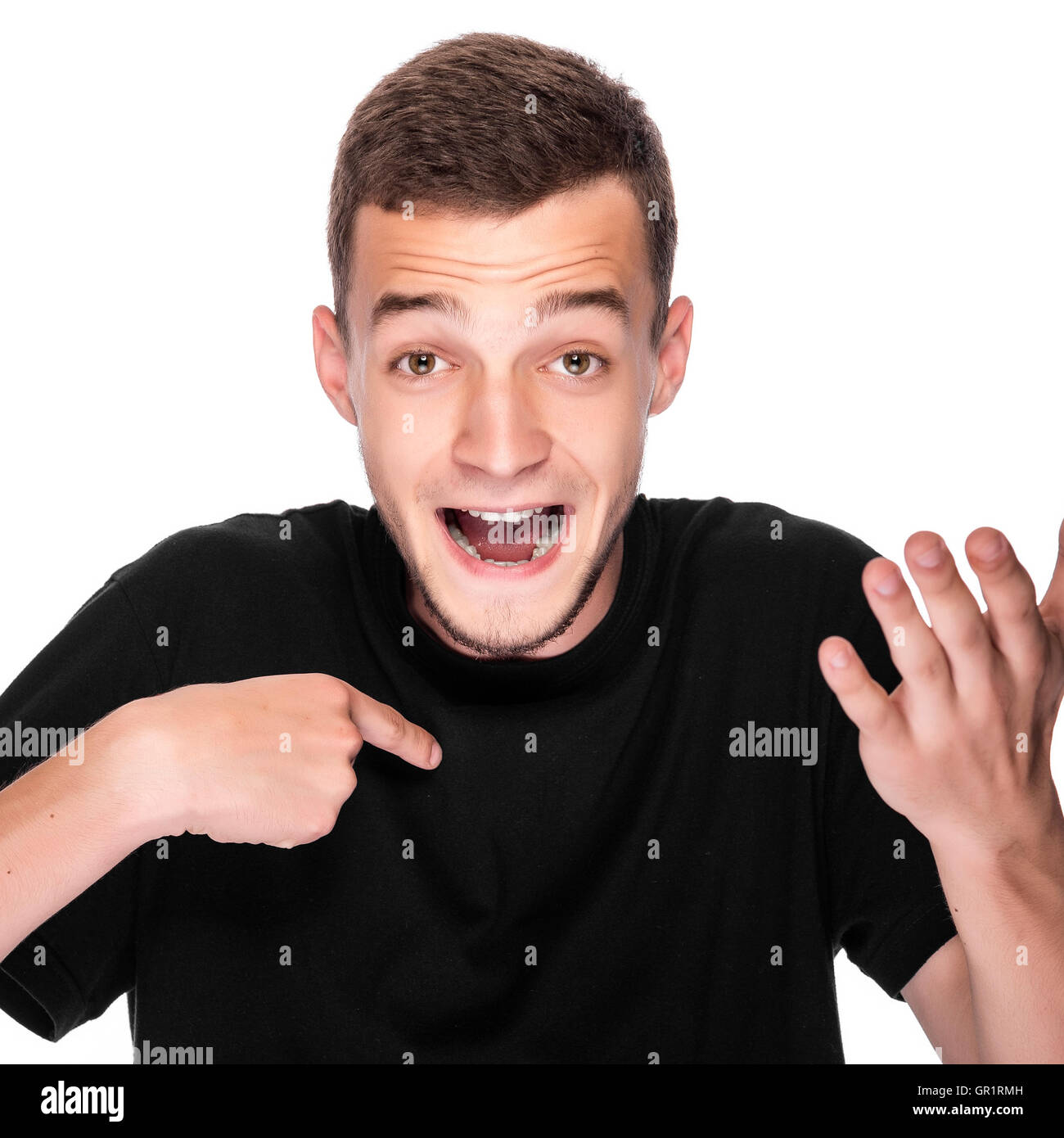 Young man in a misunderstanding on dark background Stock Photo - Alamy