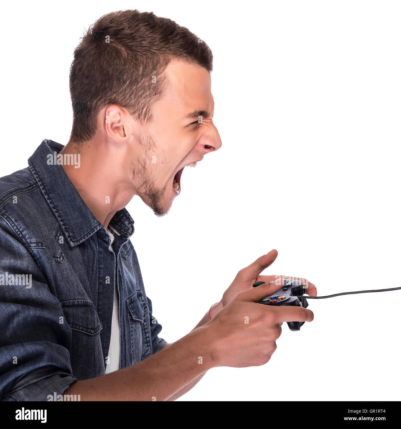 Young man playing on console or computer using a gamepad Stock Photo ...