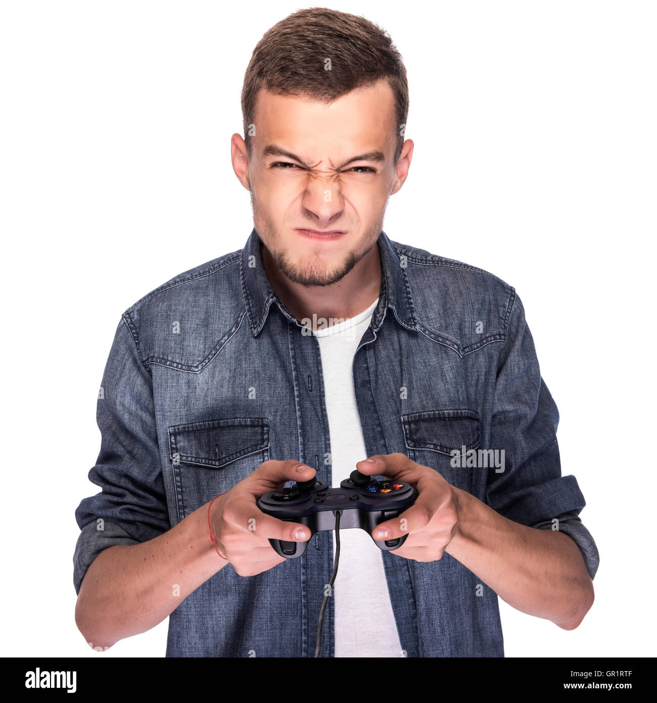 Young man playing on console or computer using a gamepad Stock Photo ...