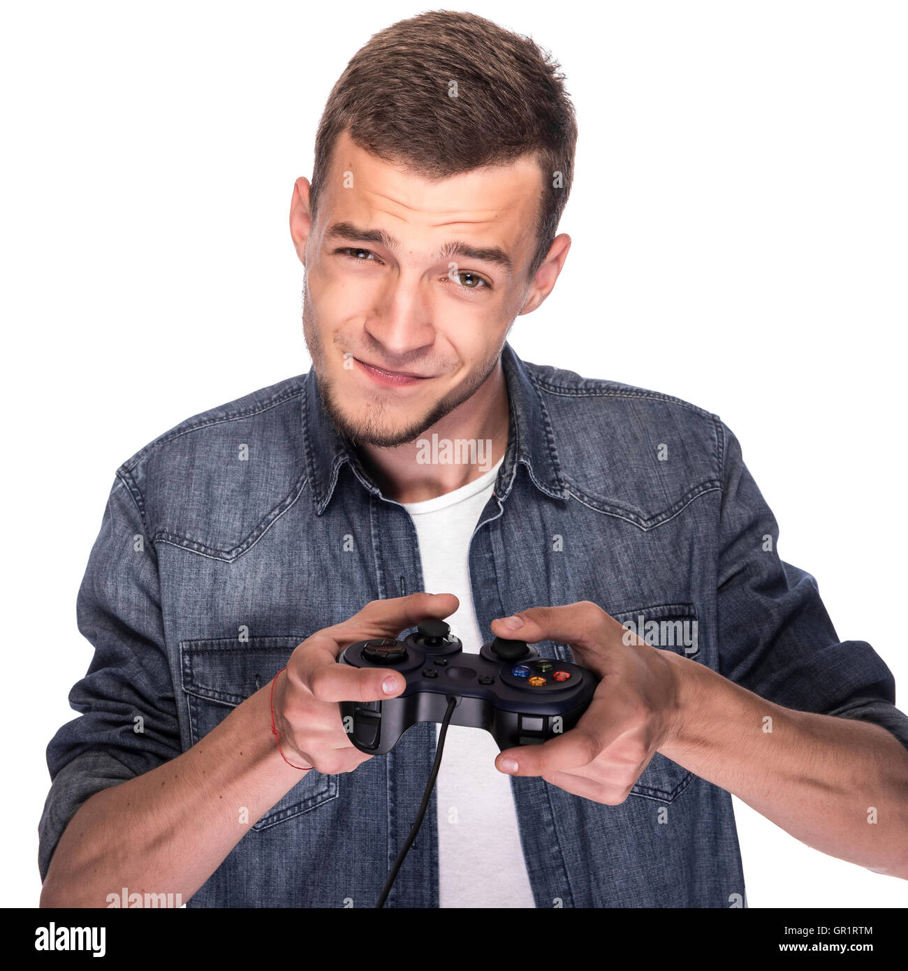 Young man playing on console or computer using a gamepad Stock Photo ...
