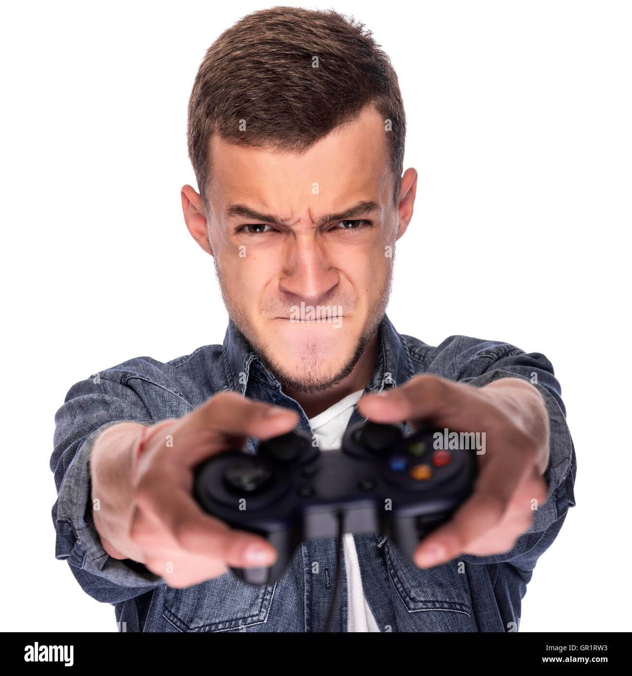 Young man playing on console or computer using a gamepad Stock Photo ...