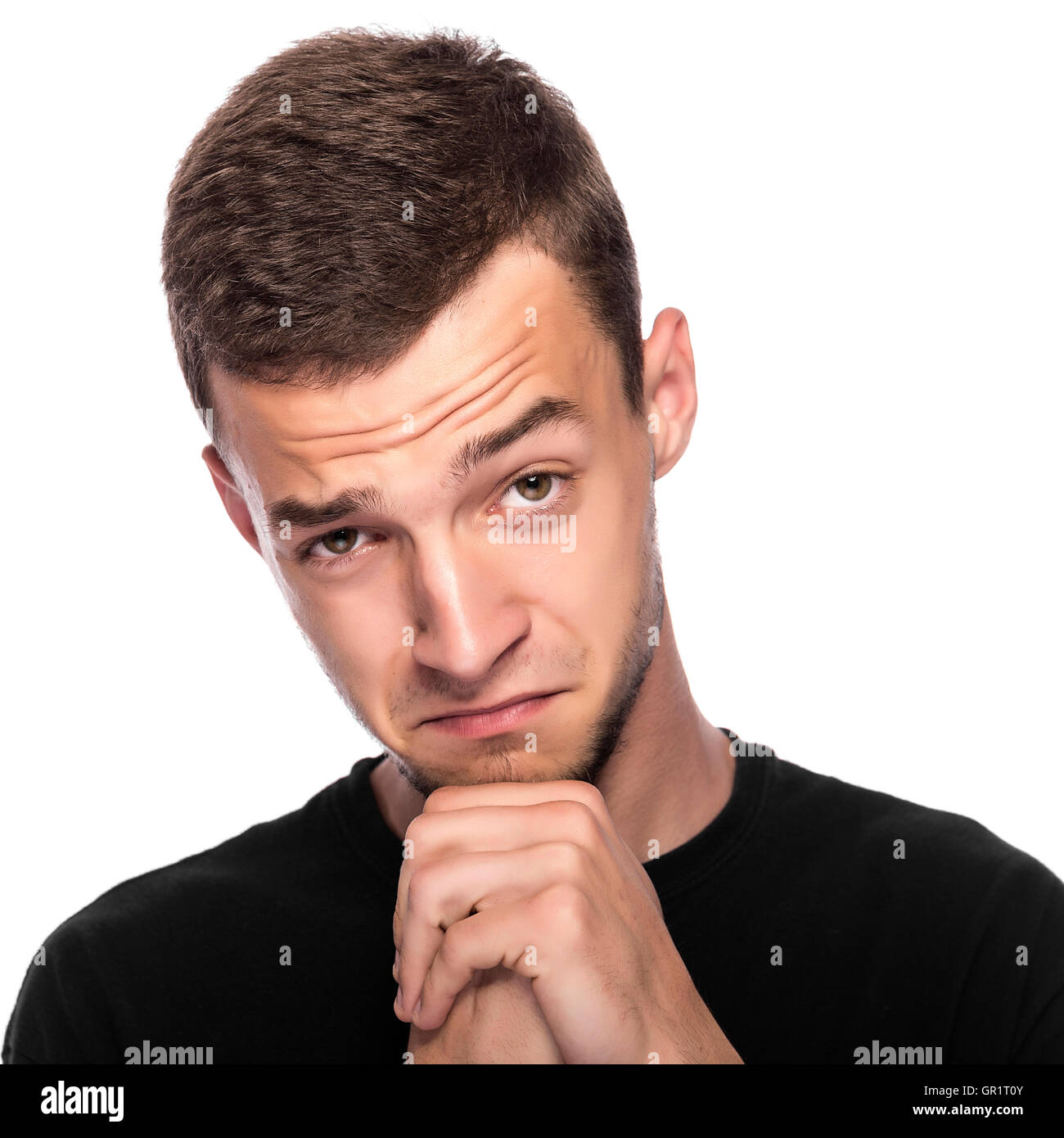 Young man asks for forgiveness on a white background Stock Photo - Alamy