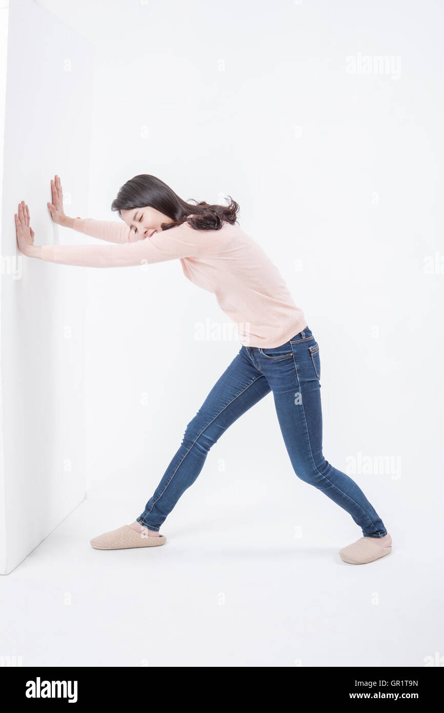Woman pushing wall hi-res stock photography and images - Alamy