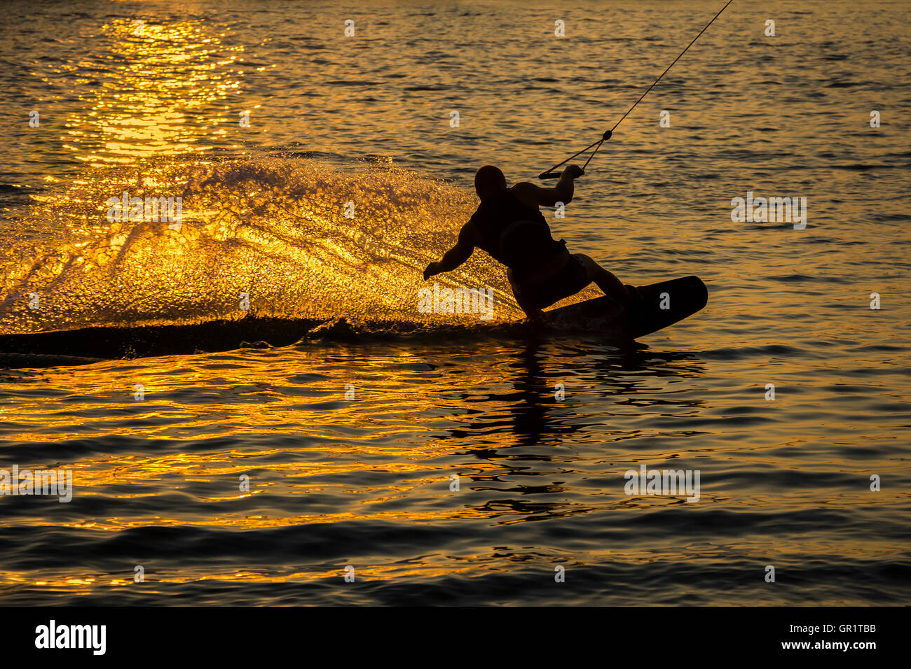 Silhouette Wakeboarder in action on sunset Stock Photo - Alamy