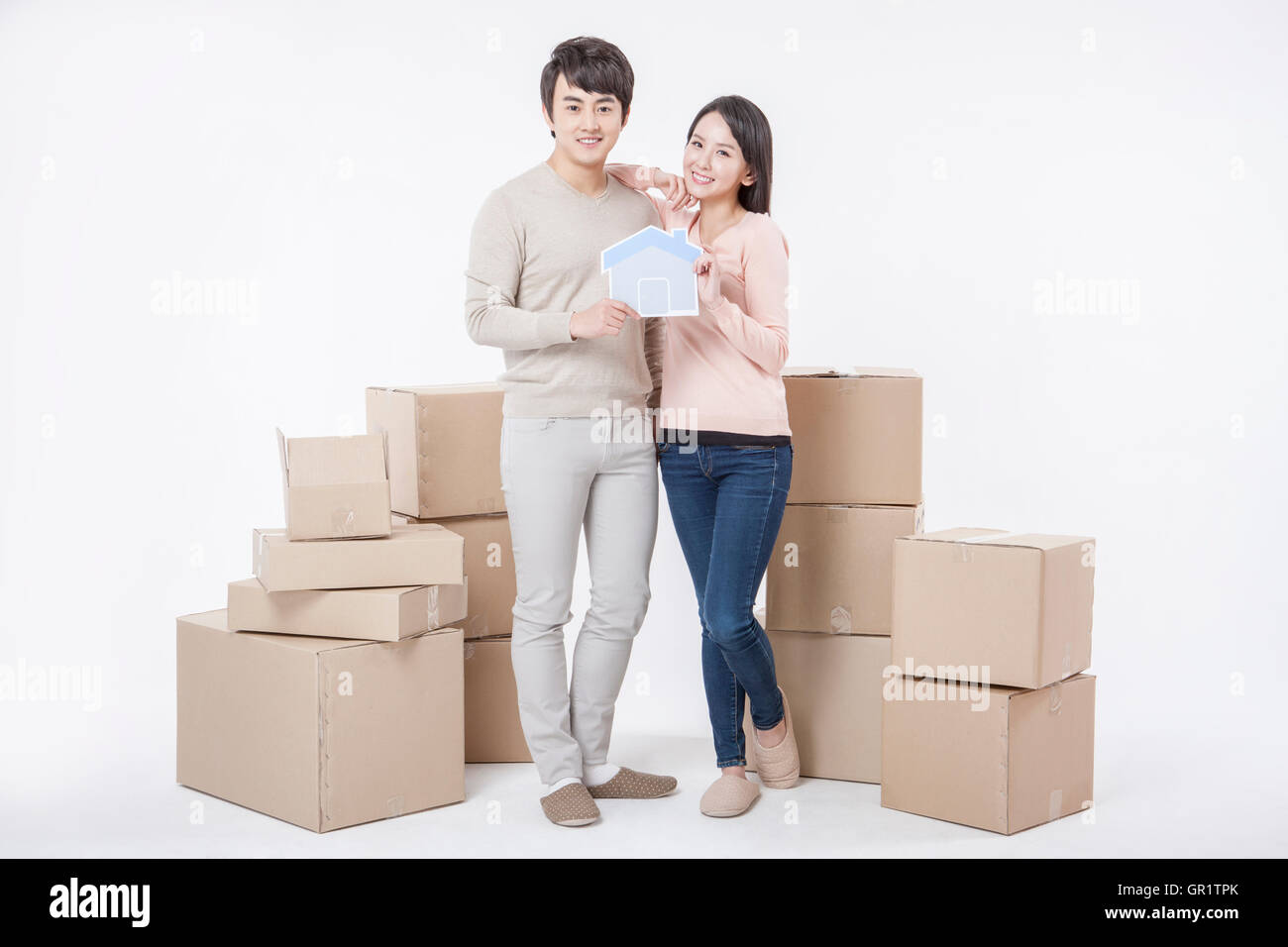 Young smiling couple with packages Stock Photo - Alamy