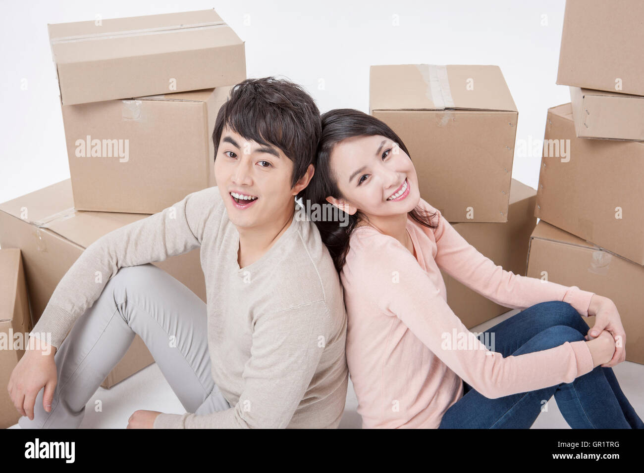 Young smiling couple with packages Stock Photo - Alamy