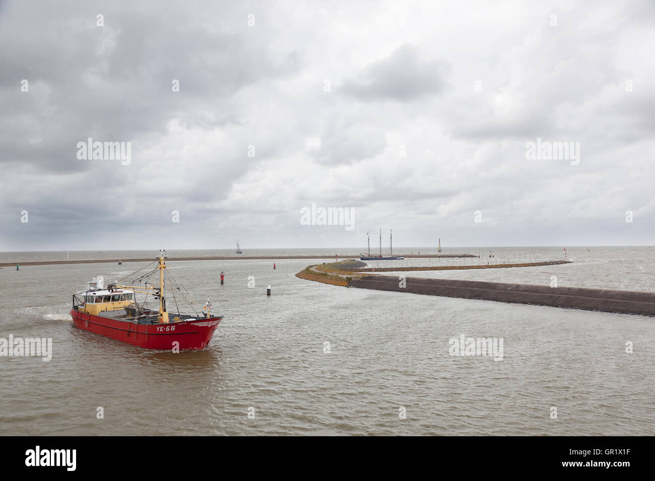 red fishing boat enters harlingen harbour near waddenzee in the ...