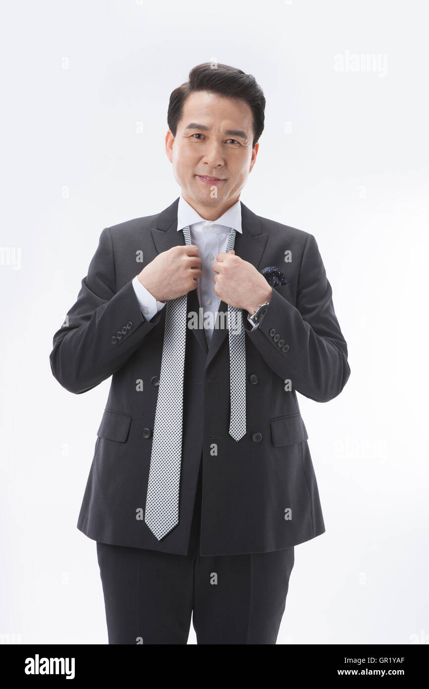 Smiling middle aged man in suit wearing a tie Stock Photo - Alamy