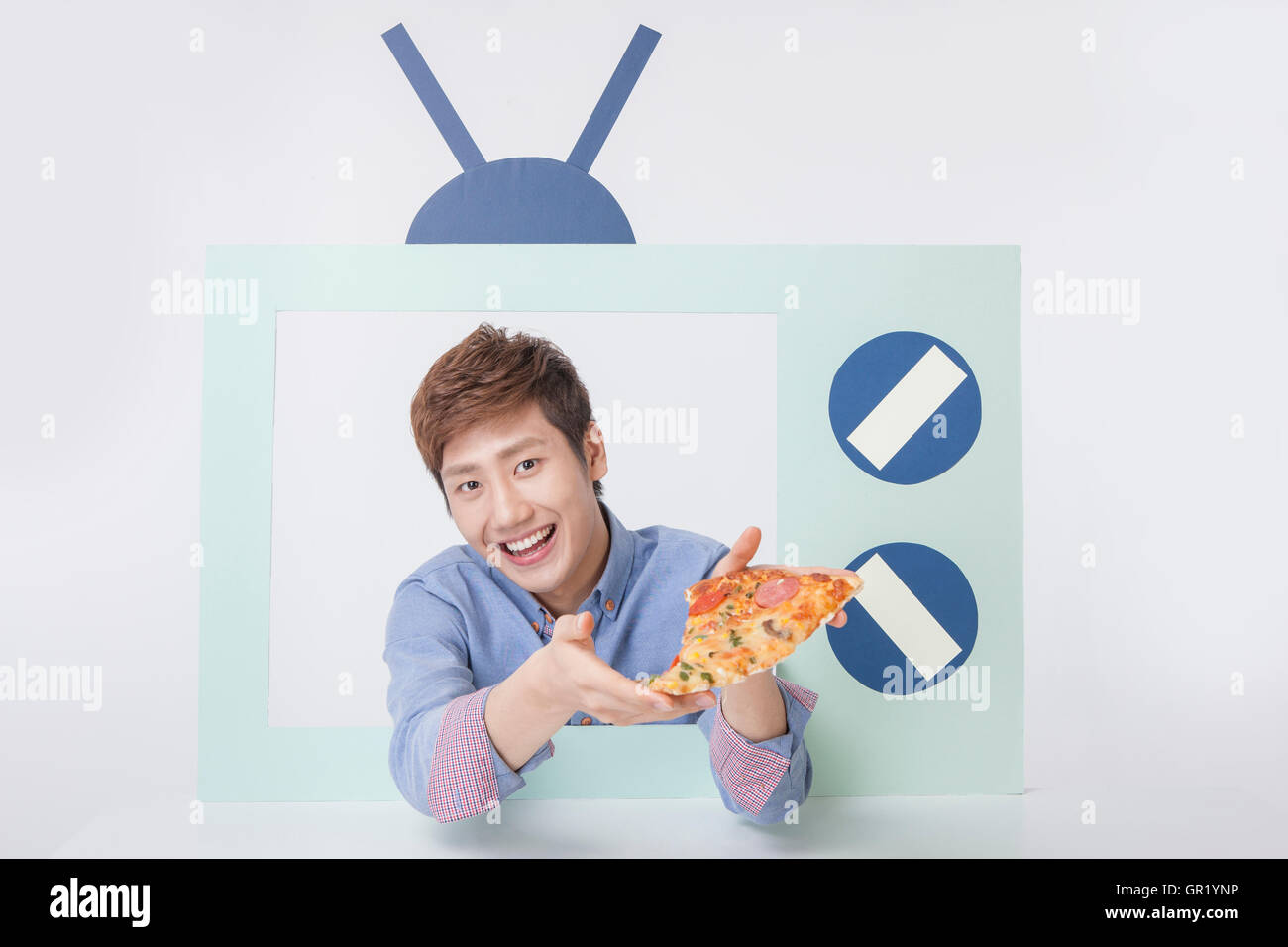 Portrait of young smiling man showing pizza on television Stock Photo ...